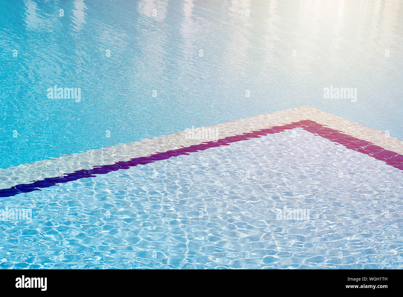 Background of water in blue swimming pool, water surface with sun ...