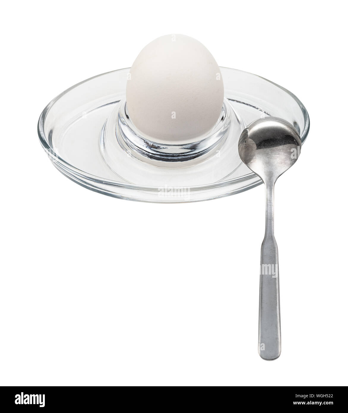 whole boiled white egg and spoon in glass egg cup isolated on white ...