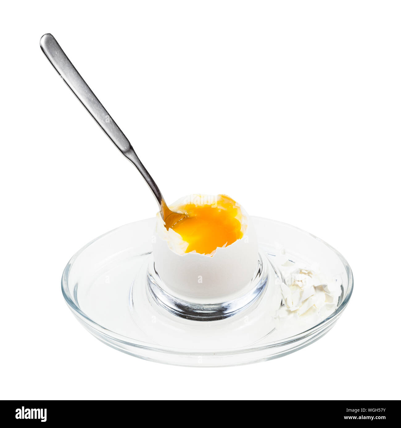 open soft-boiled white egg with spoon in glass egg cup isolated on ...