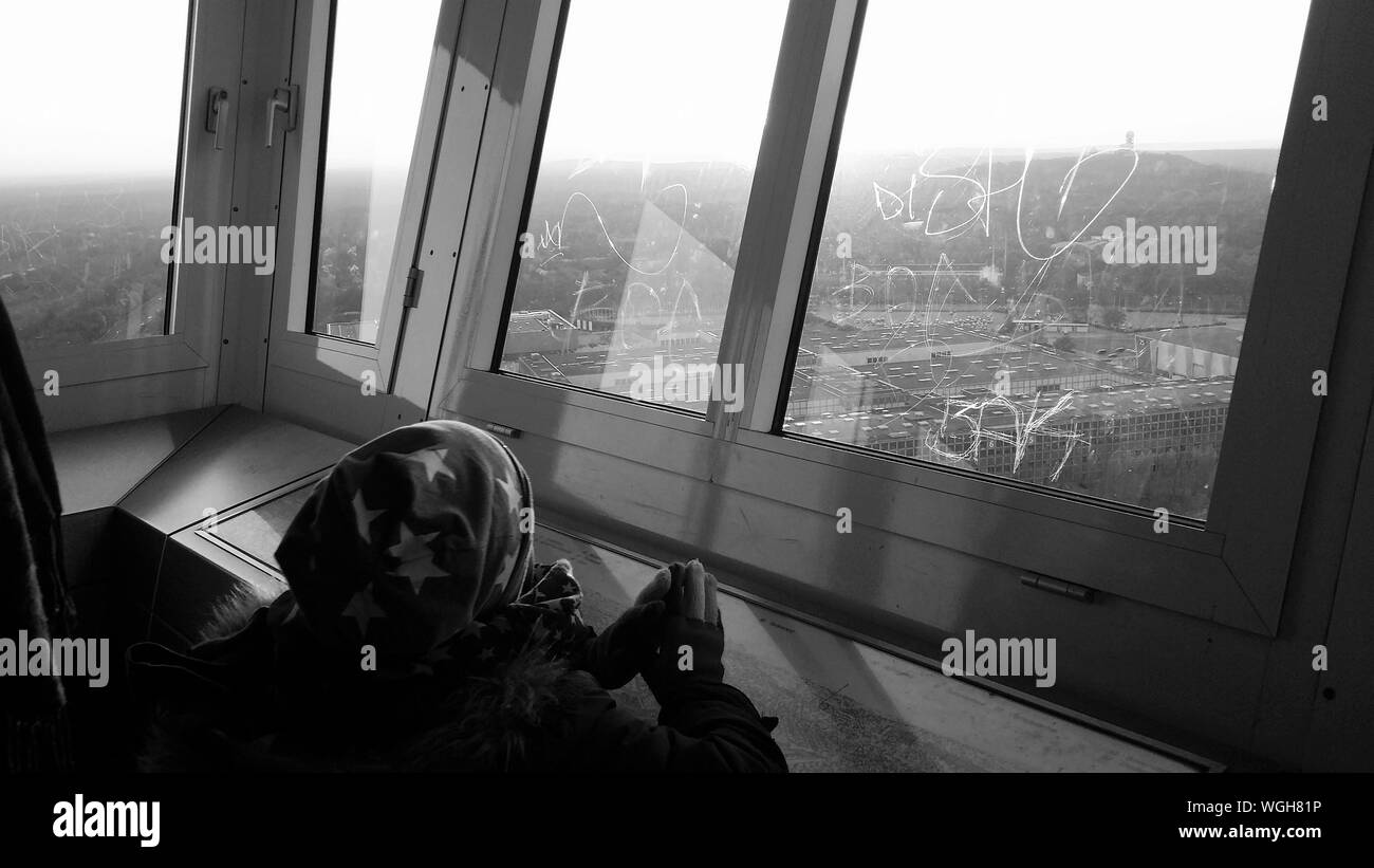 Man looking through window Black and White Stock Photos & Images - Alamy