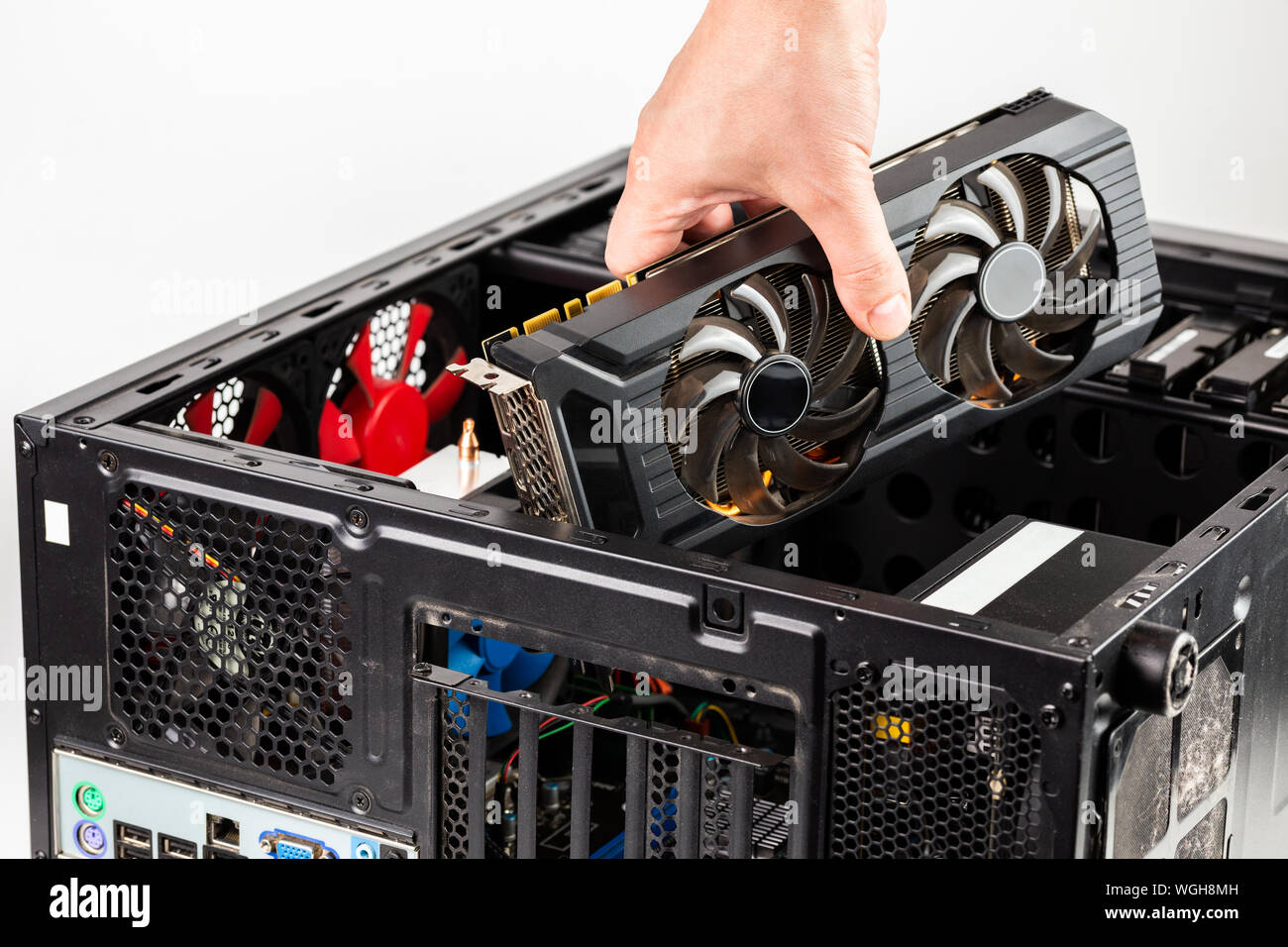 hand plugging a video card while maintenance personal computer hardware ...