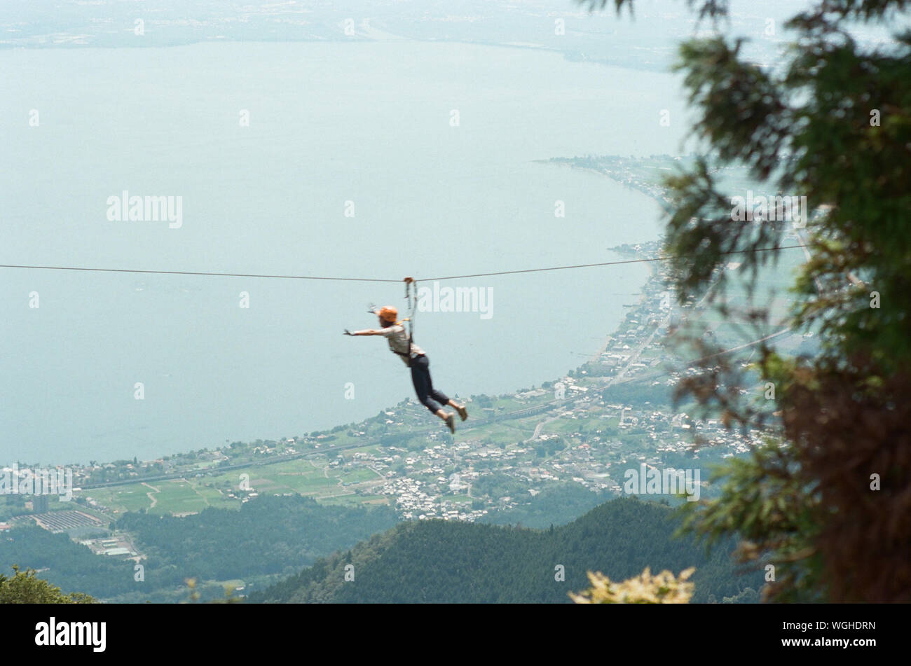 Woman hanging from rope hi-res stock photography and images - Alamy