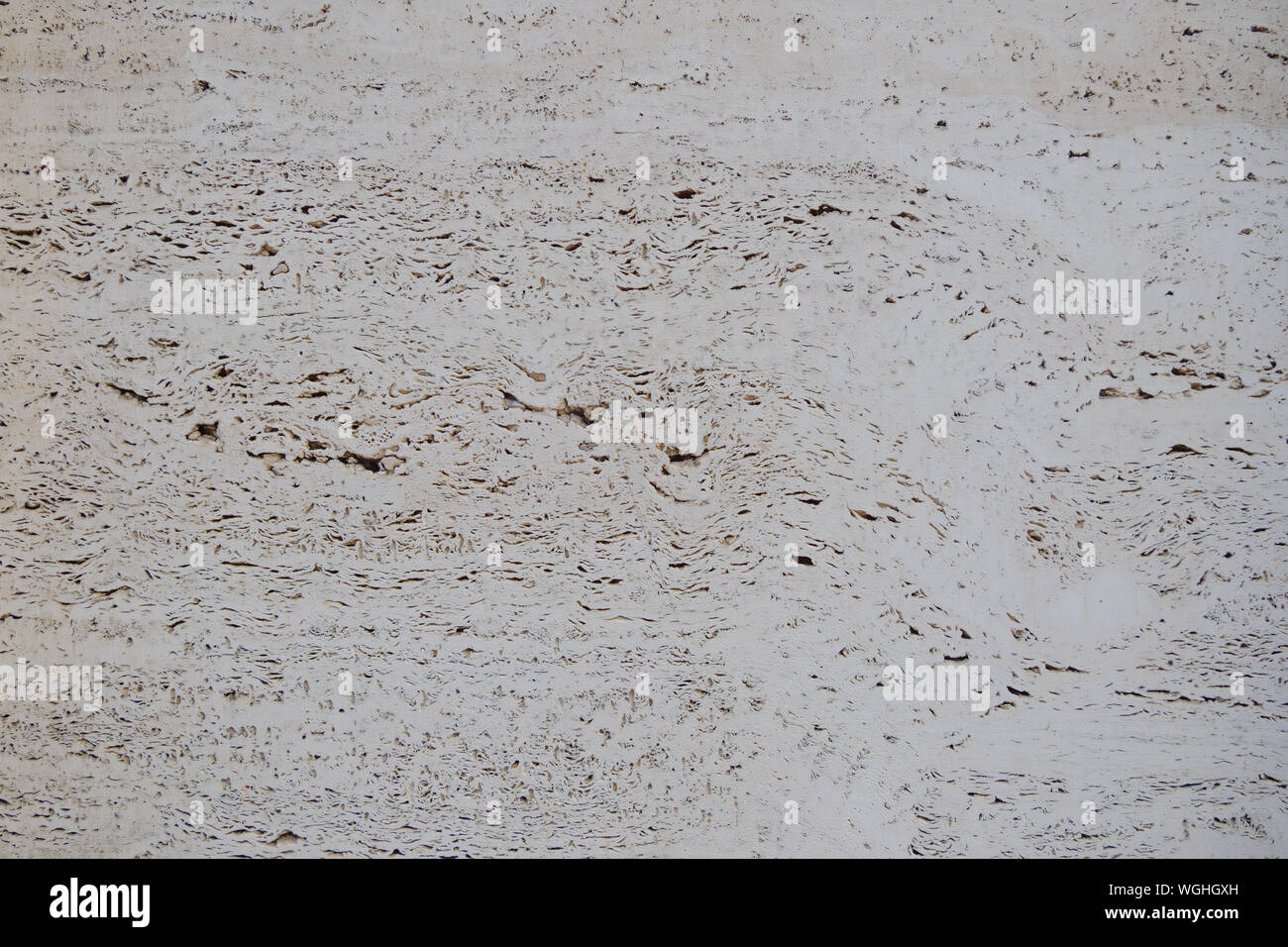 Rough white natural stone travertine with small random cavities ...