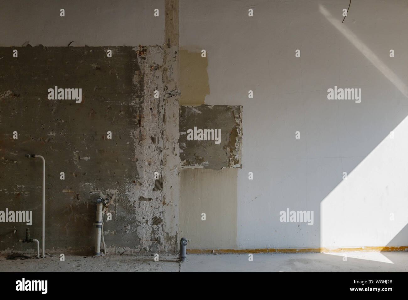 Interior view of old crack damaged white wall. Abandon empty room ...