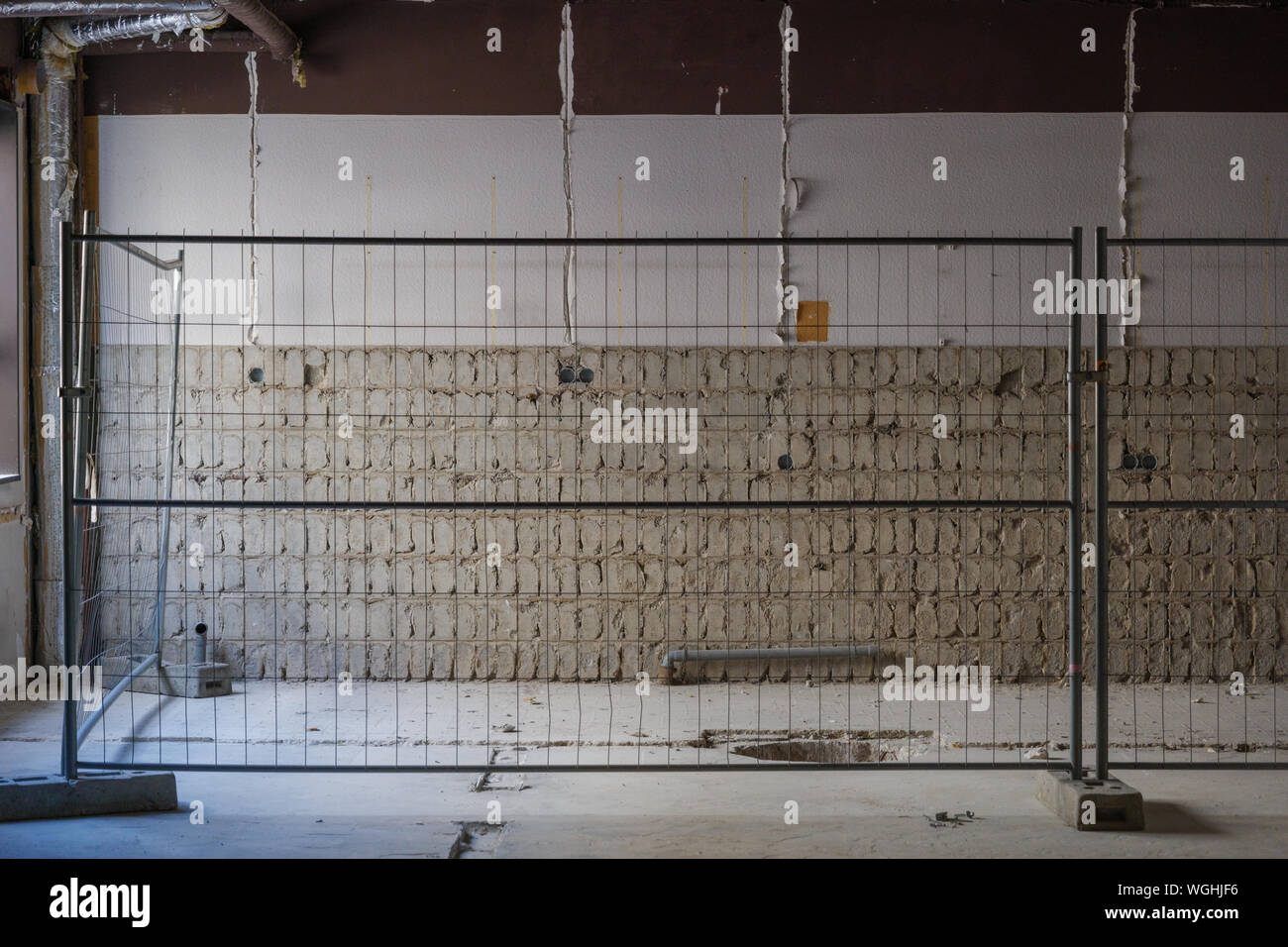 Interior with steel fence to protected people from big hole on concrete ...