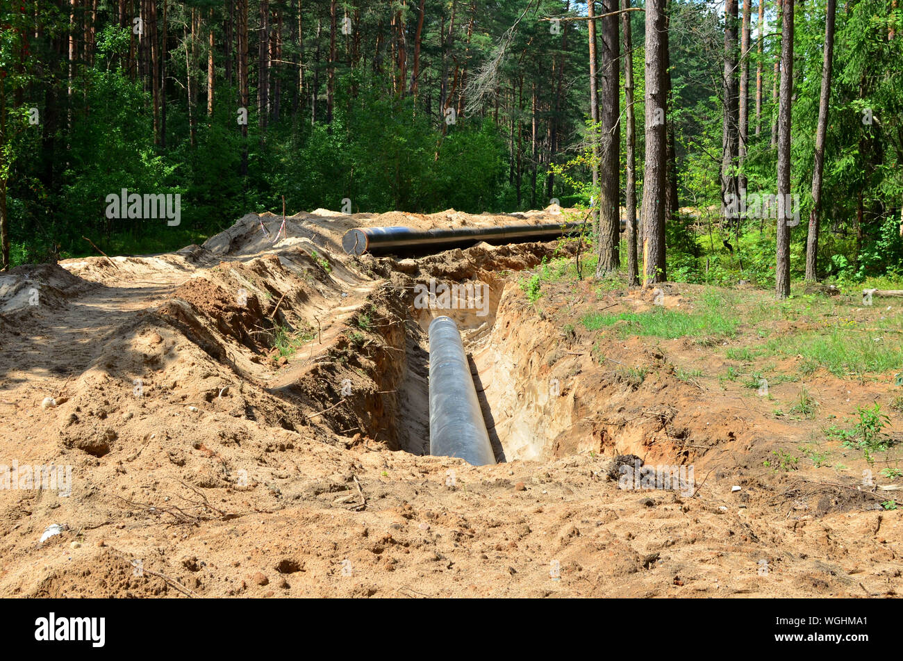 Natural gas pipeline construction work. A dug trench in the ground for ...