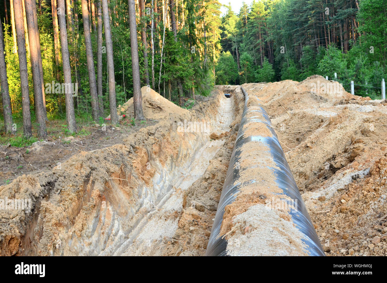 Natural gas pipeline construction work. A dug trench in the ground for ...