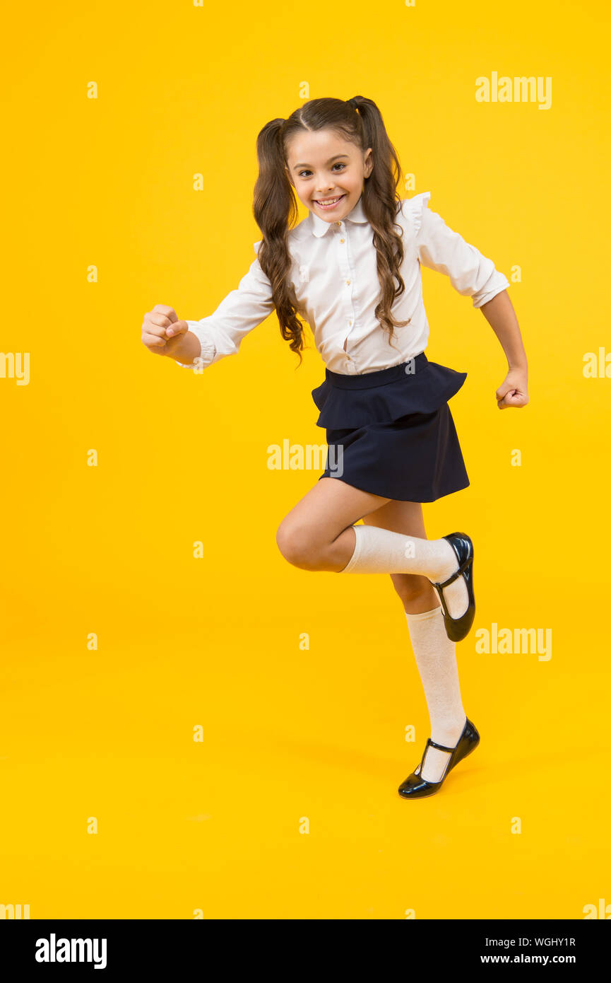 Being in a hurry. Active small child in formal wear rushing to school ...