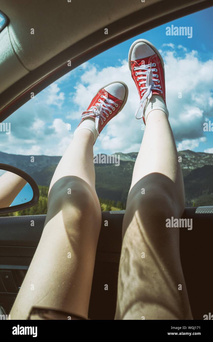 Girl legs in bright sneakers sticking out of the car Stock Photo - Alamy