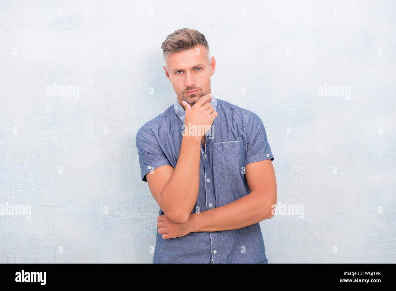 Touching chin. Man mature good looking model. What does it mean being ...