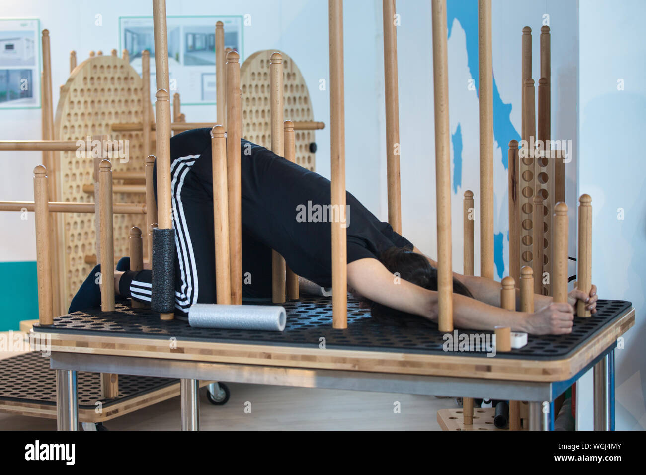 Girls doing Fitness Exercises on a Perforated Table with Movable Wooden ...