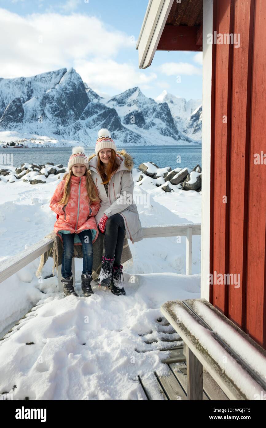 happy norwegian mom and daughter pose for the camera. Lofoten islands ...