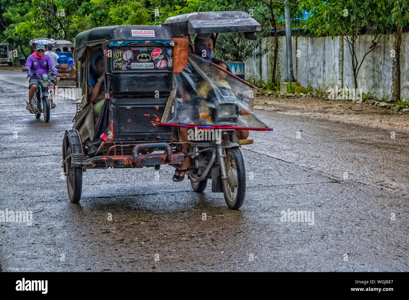 Man riding tricycle on street hi-res stock photography and images - Alamy