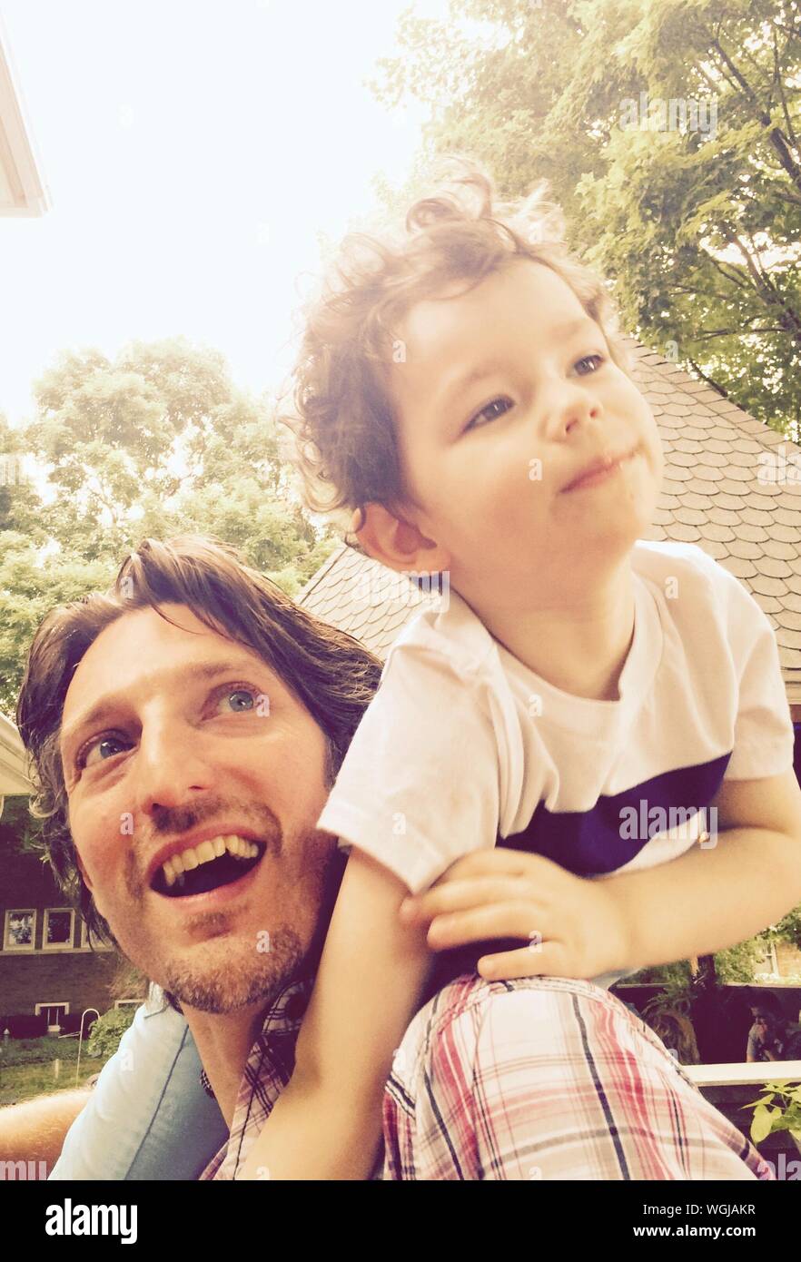 Boy carrying shoulders boy hi-res stock photography and images - Alamy