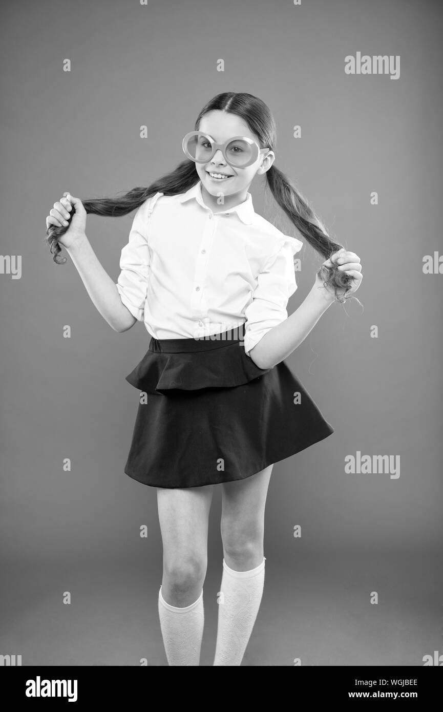 I am a girl and I am smart. Little smart schoolgirl on orange ...