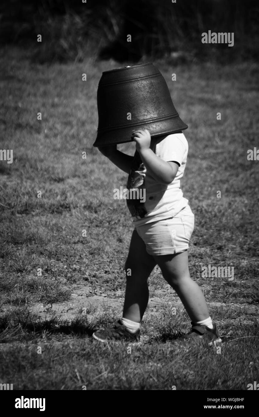 Boy with bucket on head Black and White Stock Photos & Images - Alamy