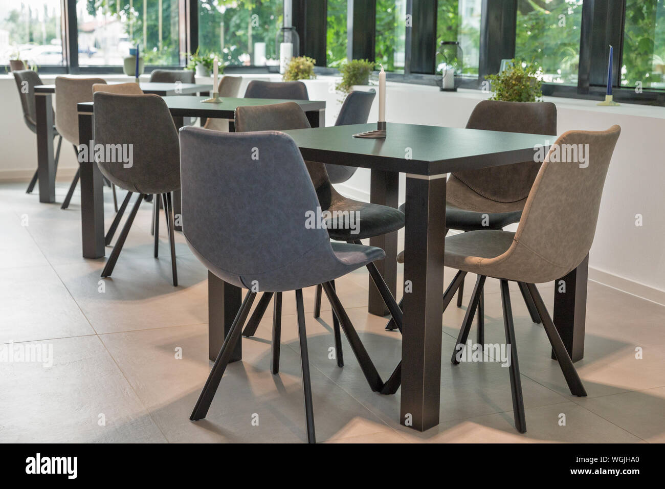Modern hotel restaurant furniture interior with windows at sunny day ...