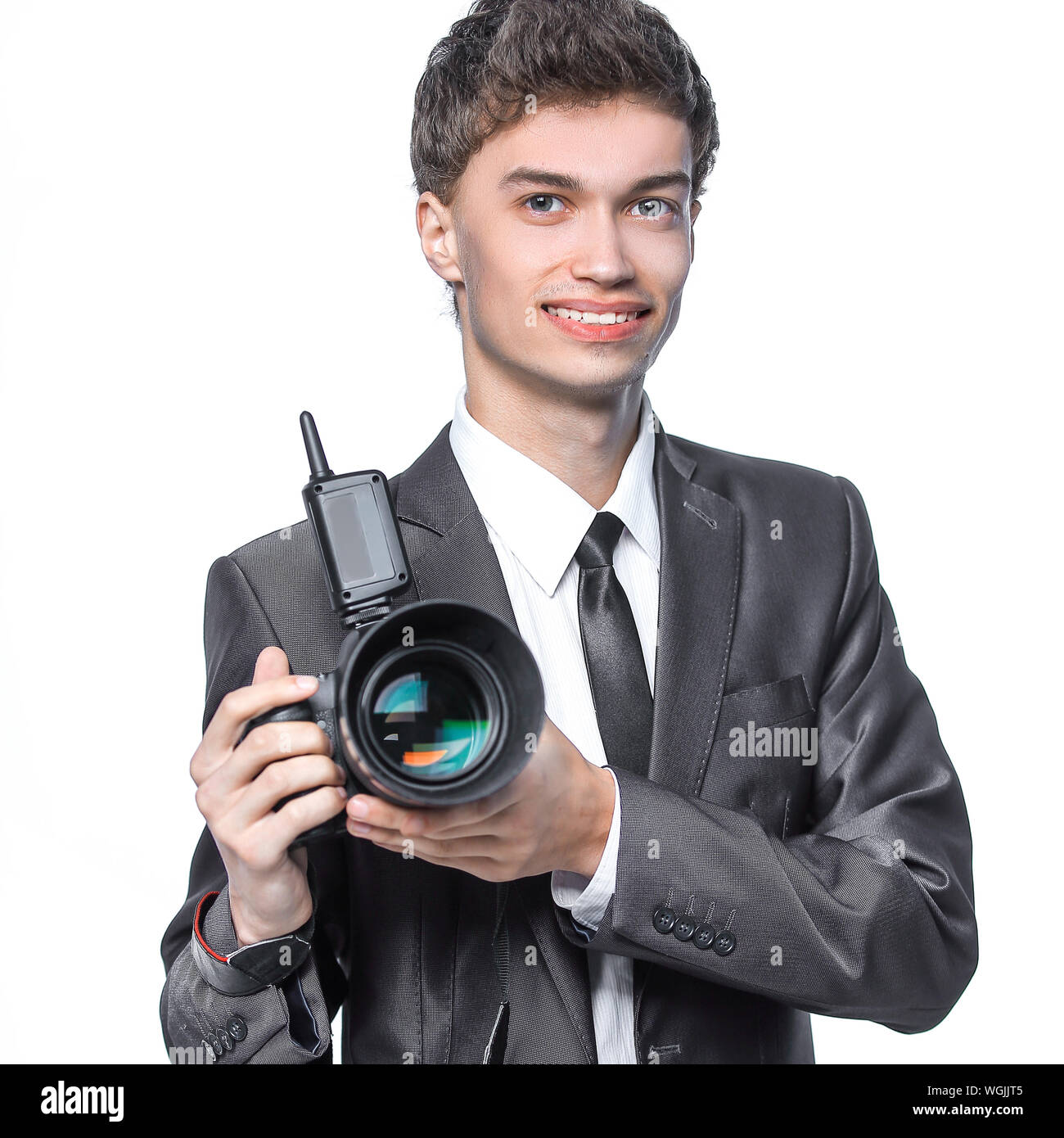 Portrait of young handsome photographer holding the camera.isolated on ...