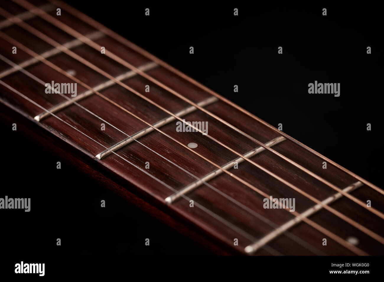 Guitar fretboard close-up. Black background Stock Photo - Alamy