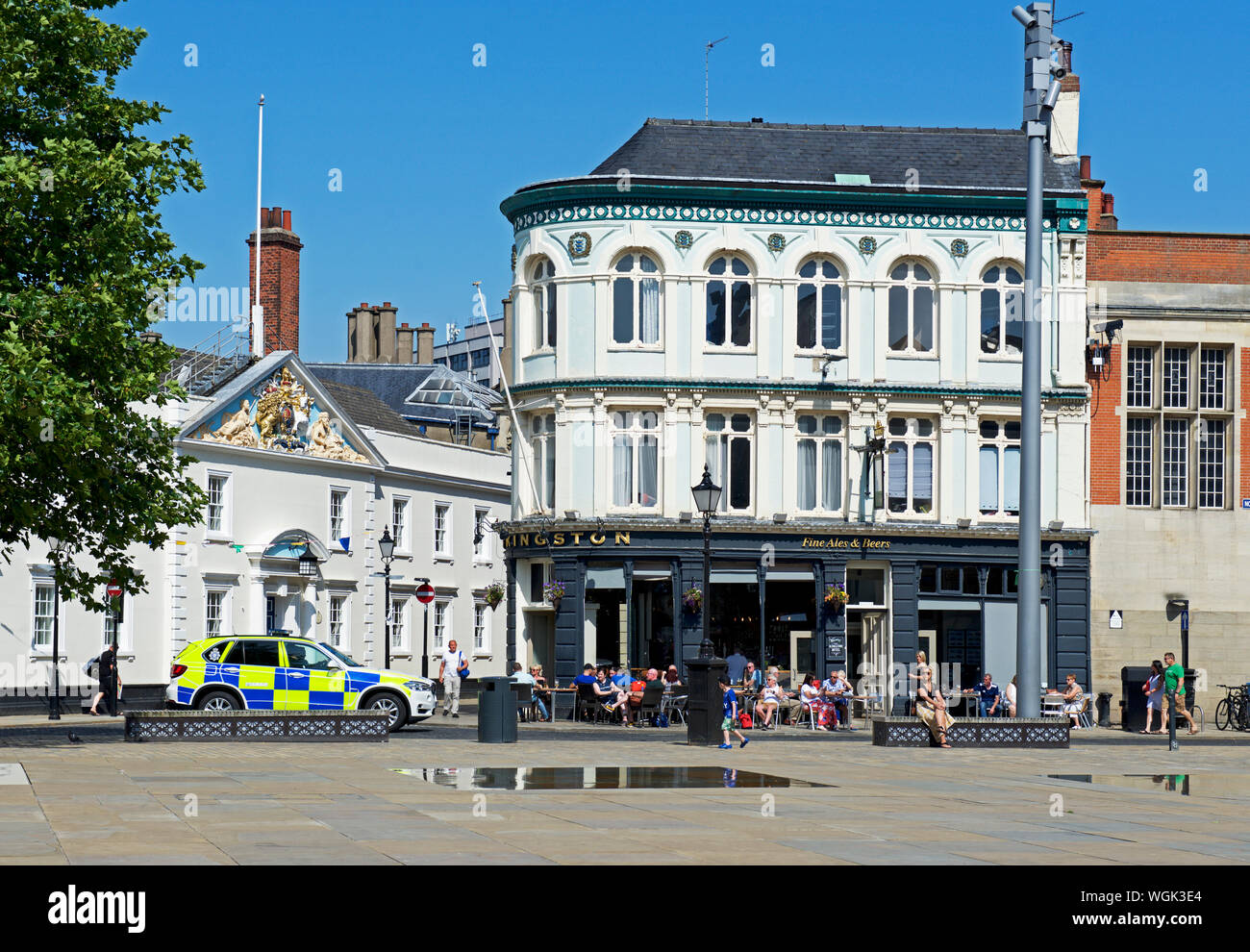Drinkers - and police car - outside the Kingston pub in Trinity Square ...