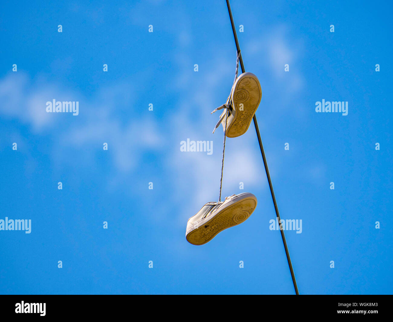 Sneakers hanging telephone wire hi-res stock photography and images - Alamy