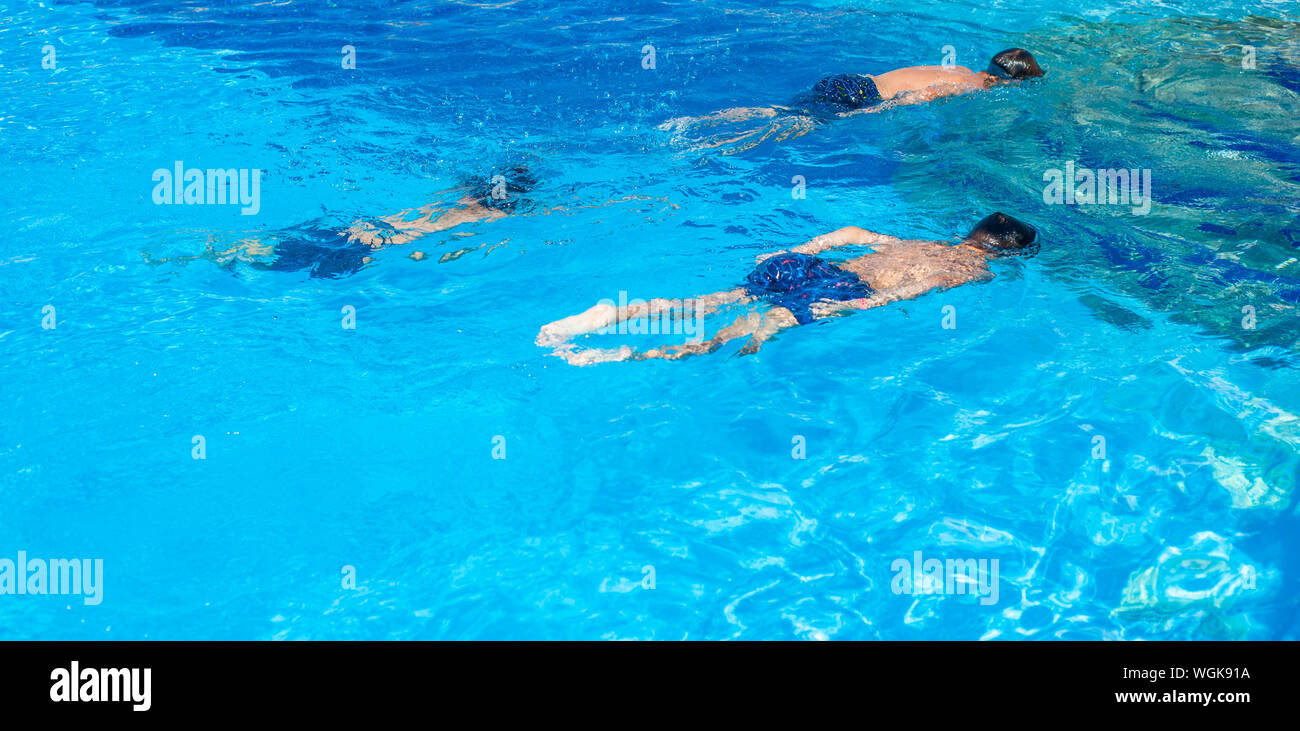Happy children diving in the pool. Happy child is swimming in the pool ...