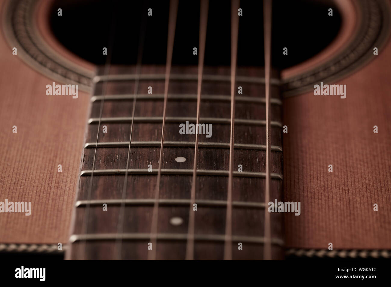 Acoustic guitar fretboard. Close up Stock Photo - Alamy