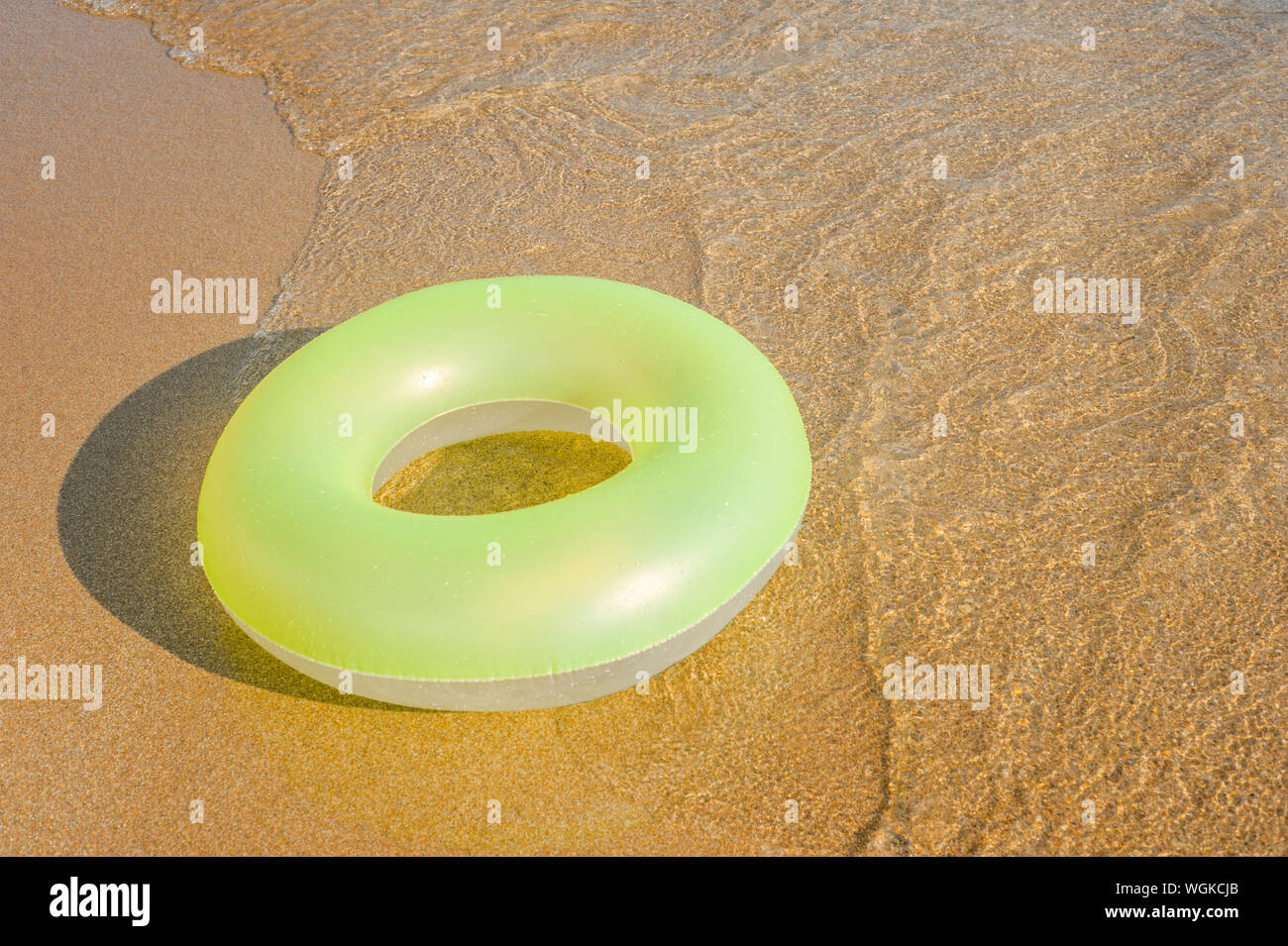 Green Rubber Ring In The Sea Stock Photo - Alamy