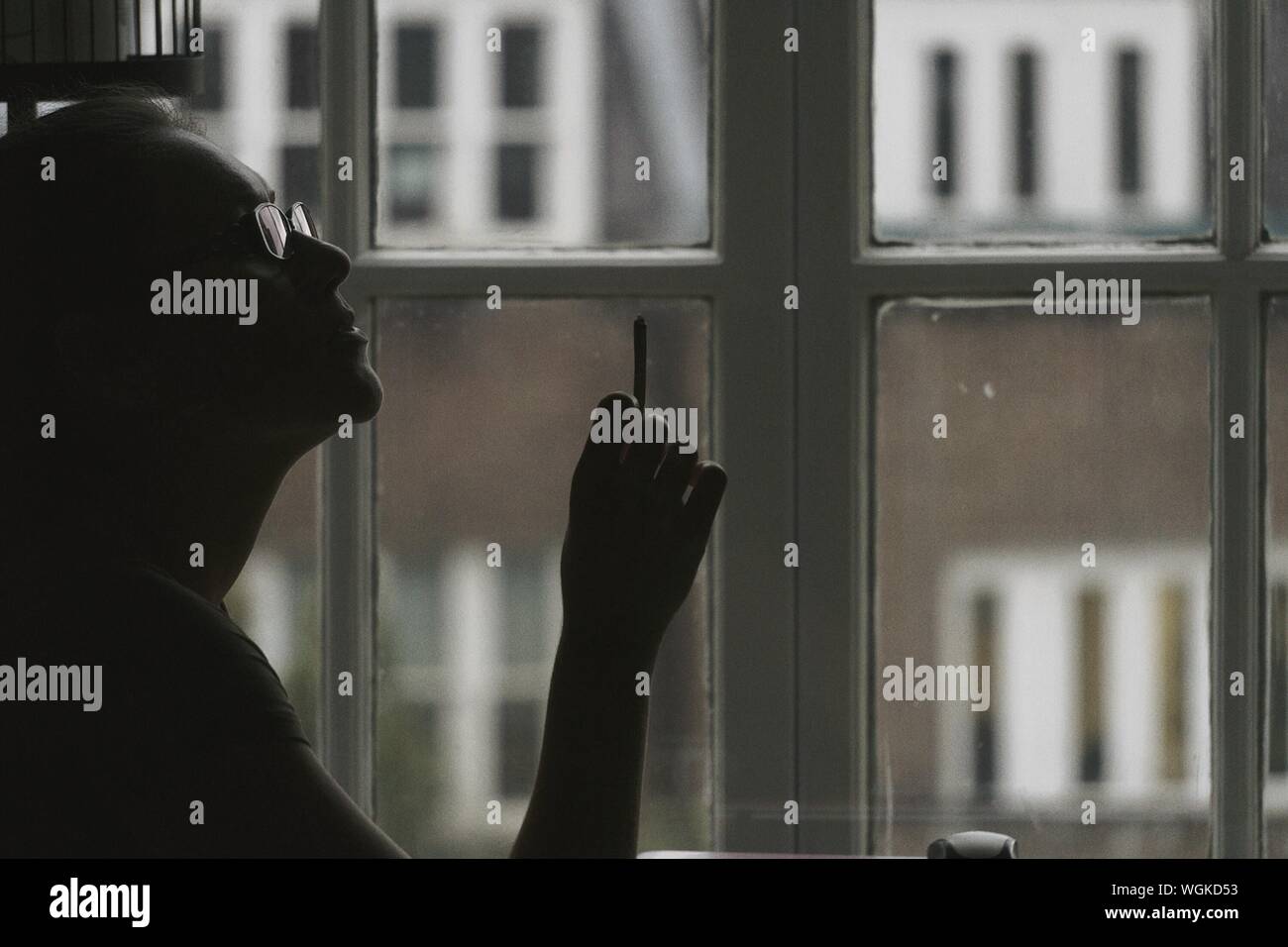 Woman smoking by window High Resolution Stock Photography and Images ...