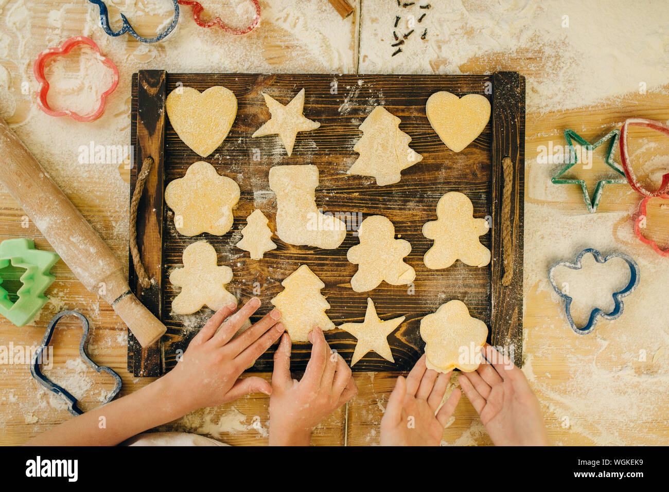 Little girls chefs spread out cookies on board Stock Photo - Alamy