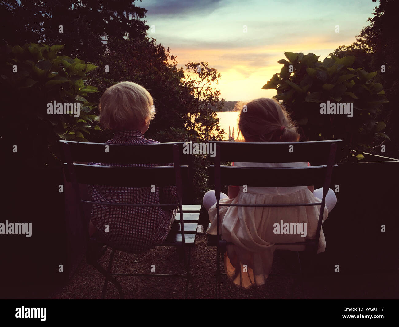 Boy girl sitting on chair hi-res stock photography and images - Alamy