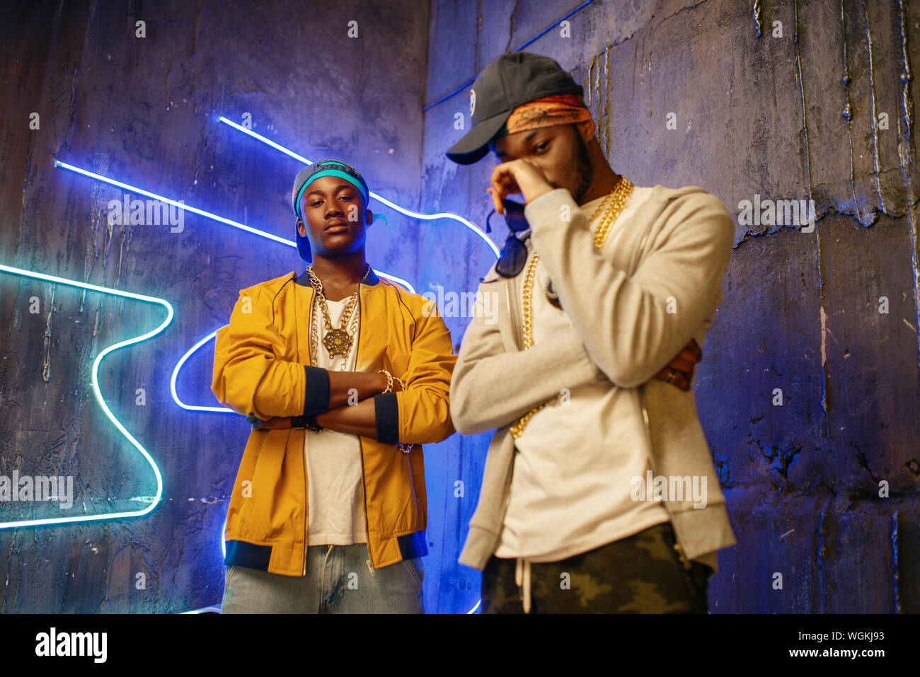 Two black rappers, neon lights on background Stock Photo - Alamy