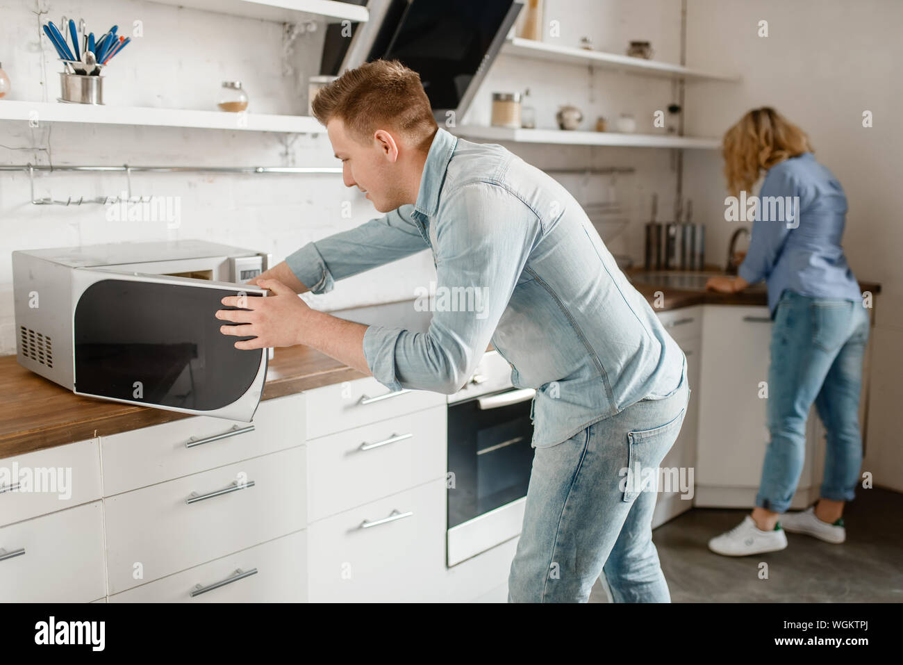 Young couple prepares meal together hi-res stock photography and images ...