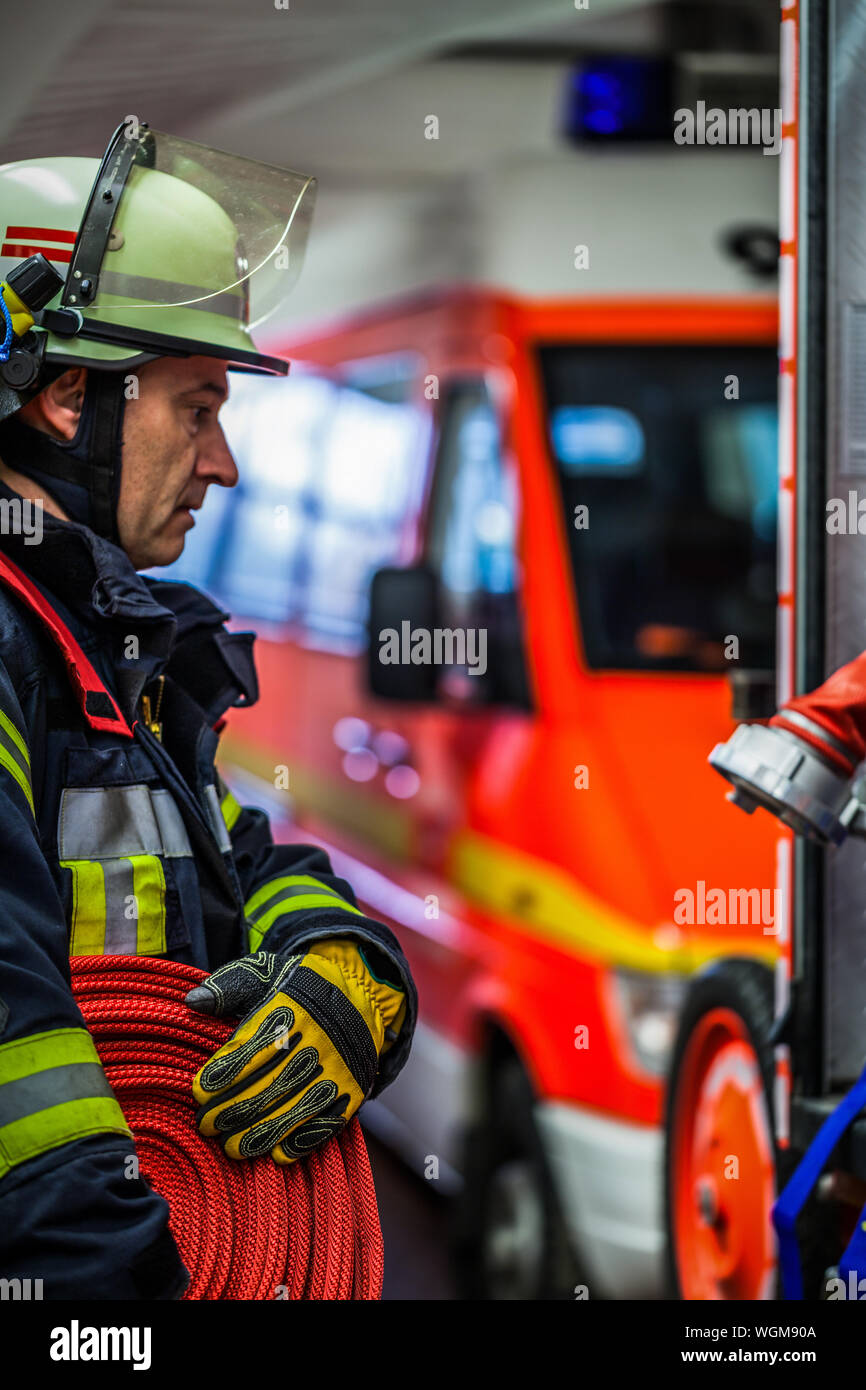Firefighter with hose hi-res stock photography and images - Alamy