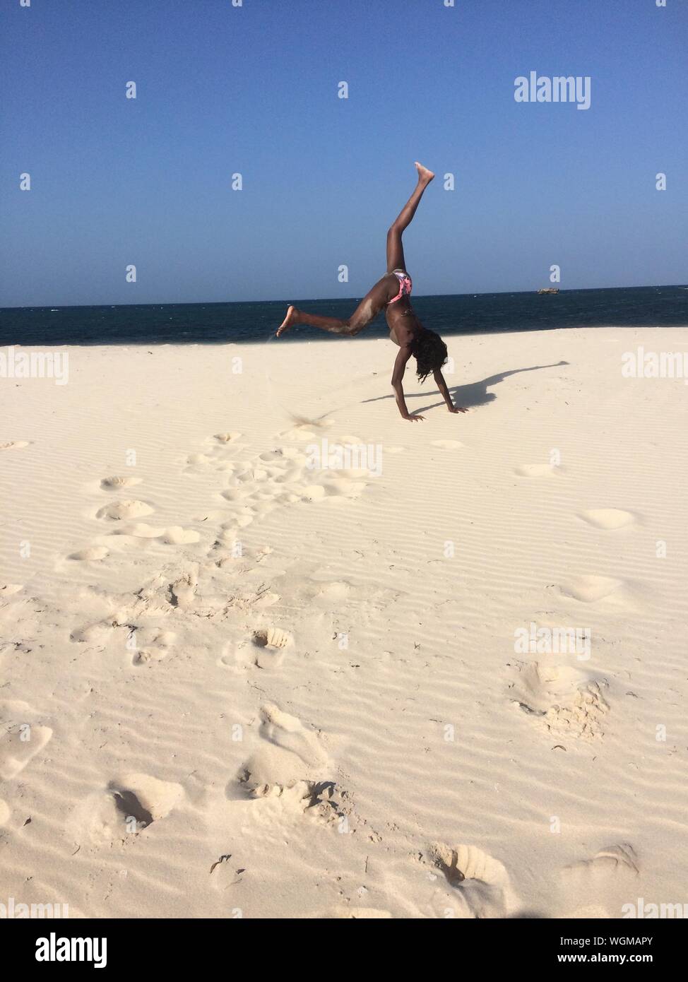 Woman doing handstand on beach hi-res stock photography and images - Alamy