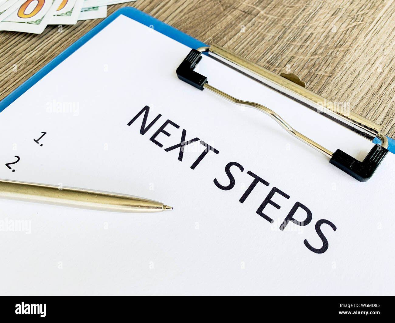 Clipboard with text next step on wood desk Stock Photo - Alamy