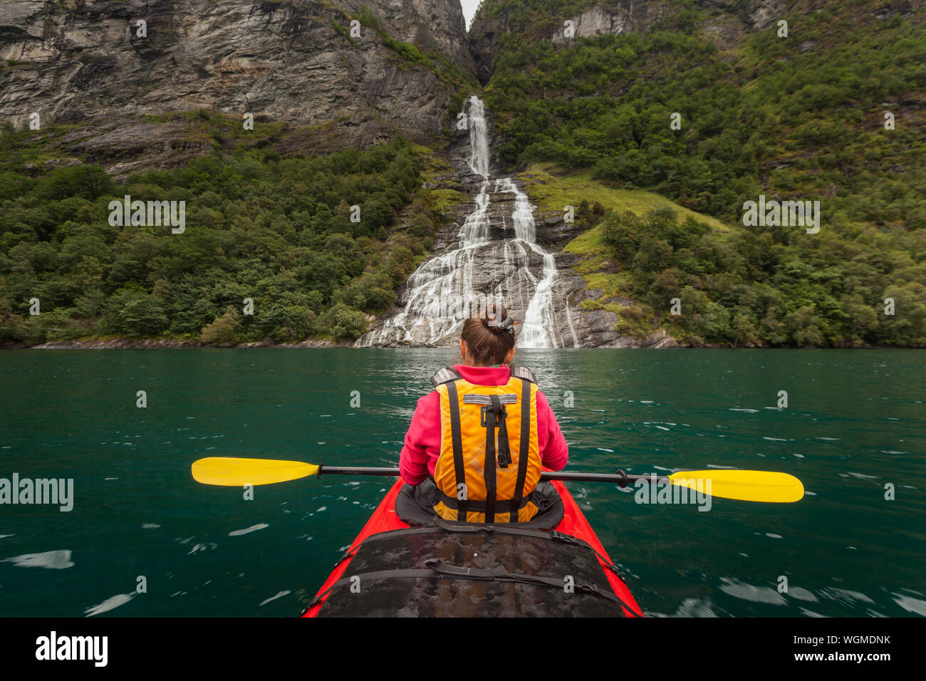 Little kayak in a lake or in a big river with a beautiful girl traveler ...