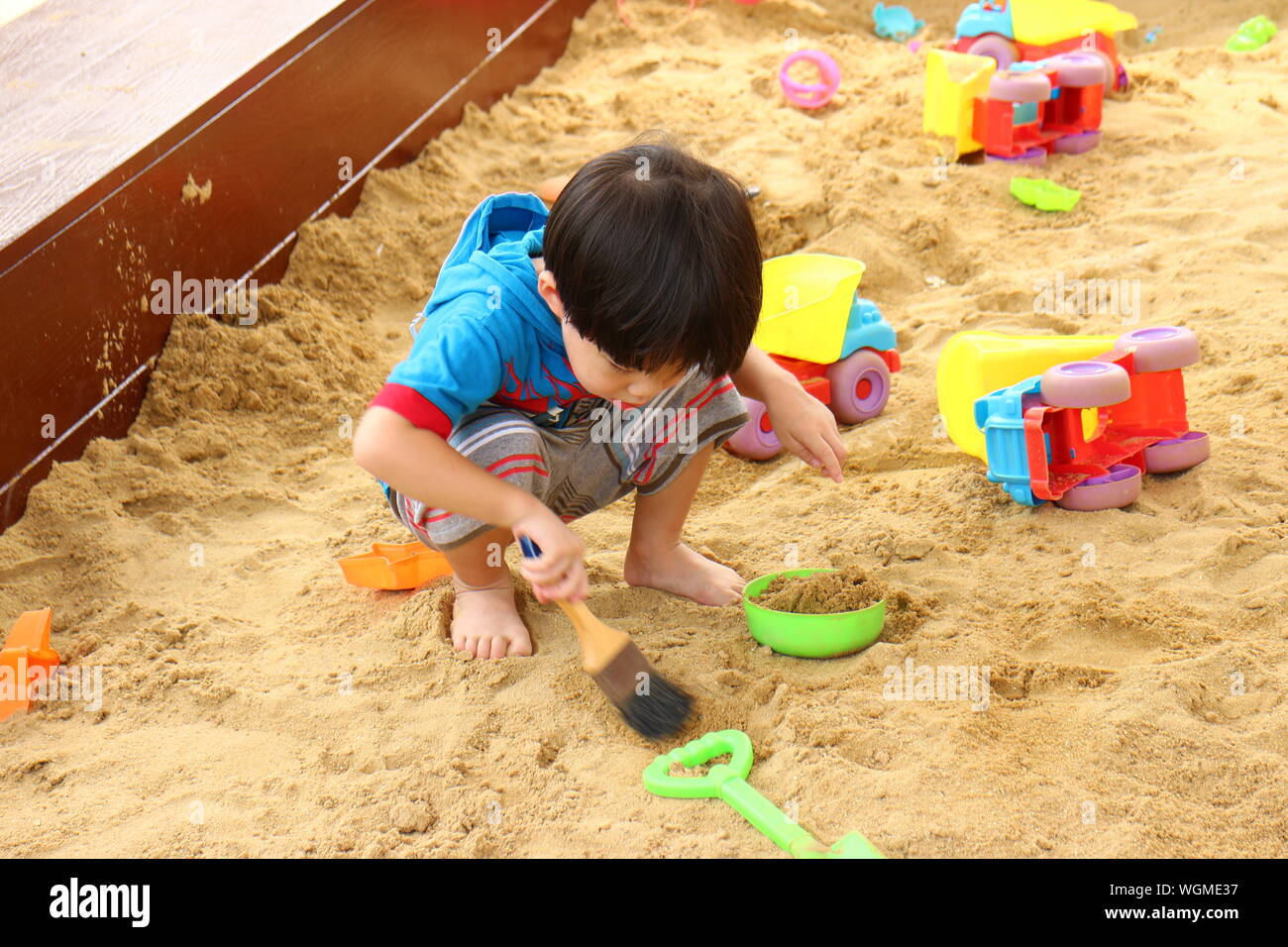 Boy Playing On Sand Stock Photo - Alamy
