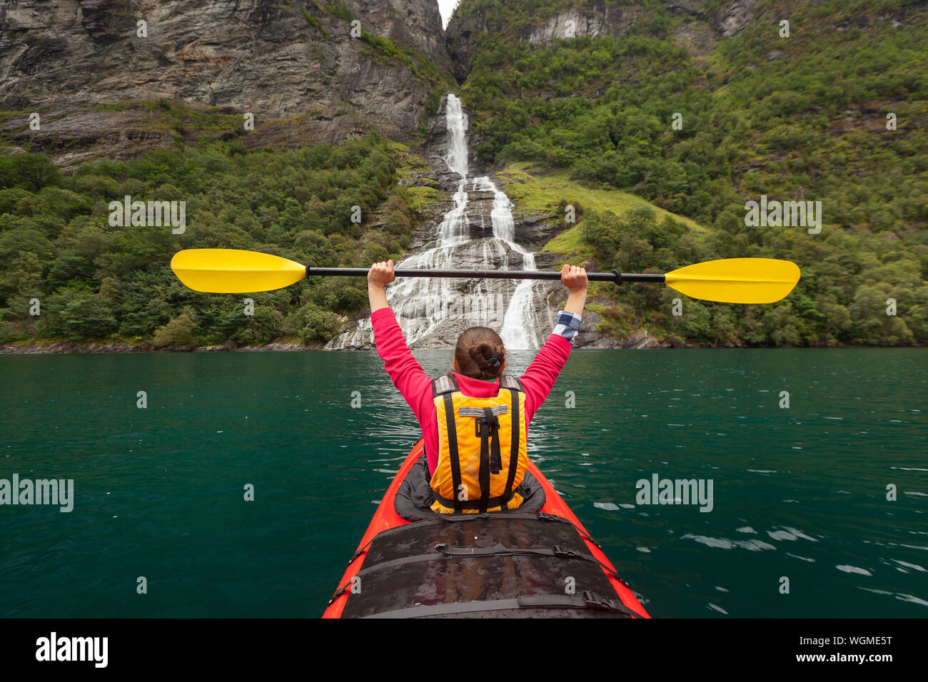 Little kayak in a lake or in a big river with a beautiful girl traveler ...