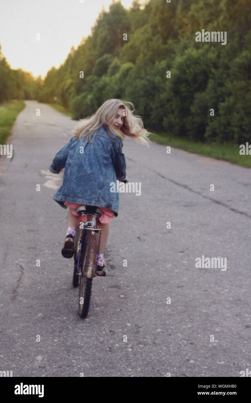 Woman with bicycle on shoulder hi-res stock photography and images - Alamy