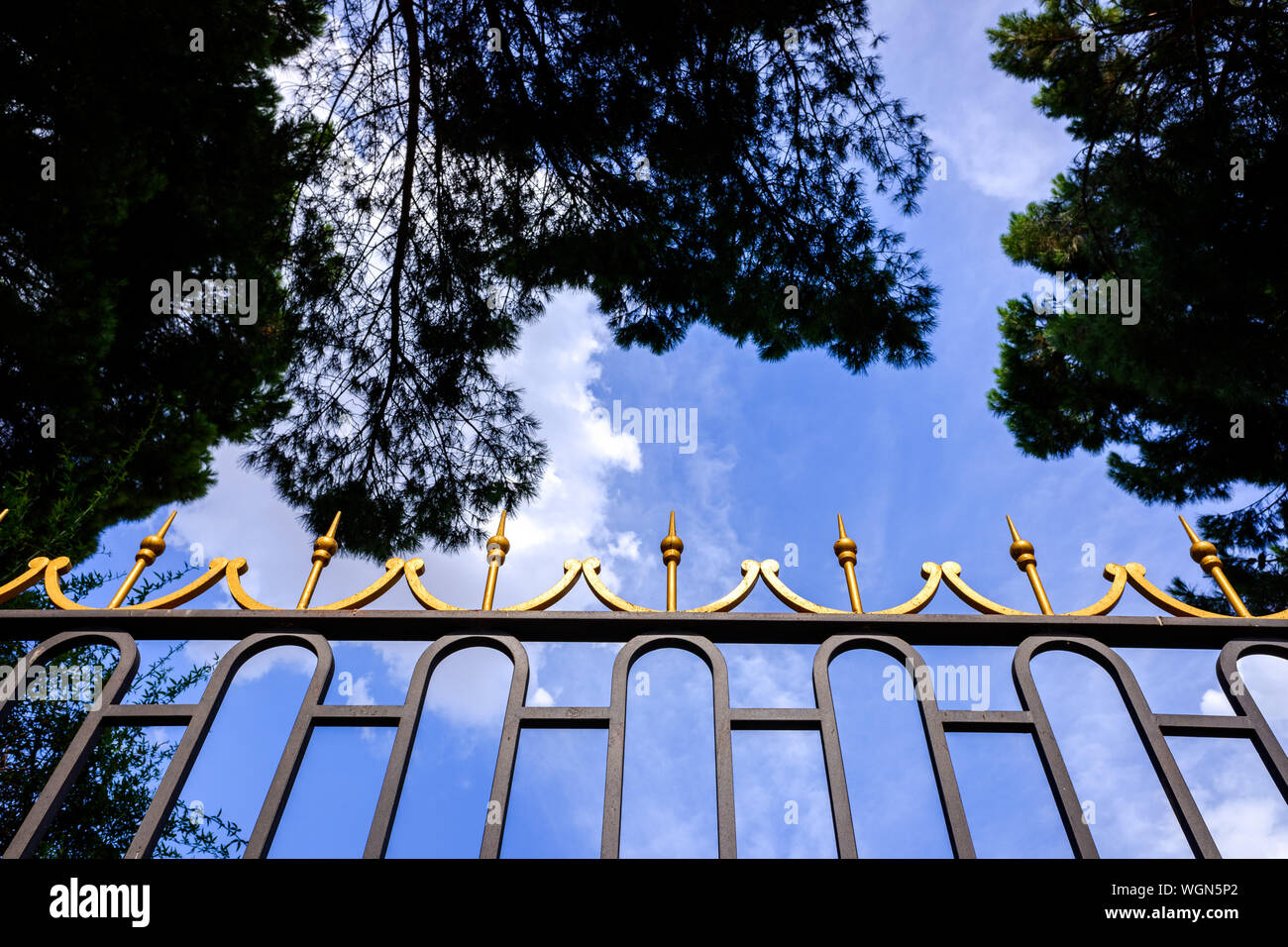 High metal fence to protect something valuable in old style Stock Photo ...