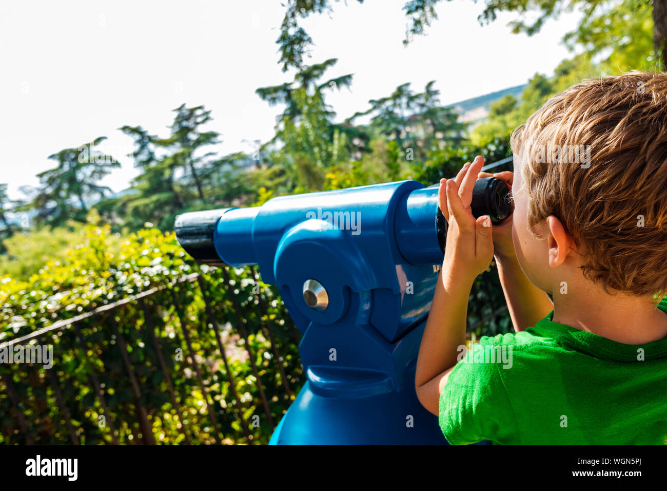 Child scrutinizes his future looking through a telescope Stock Photo ...