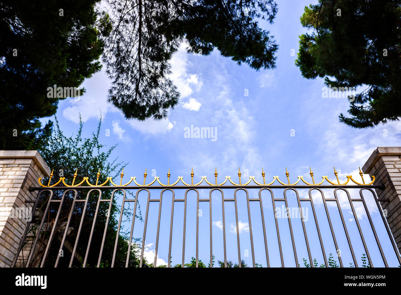 High metal fence to protect something valuable in old style Stock Photo ...