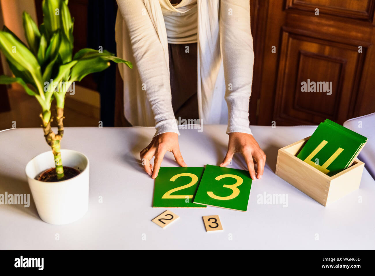 Hands of a montessori teacher guide presenting how to make sums Stock ...