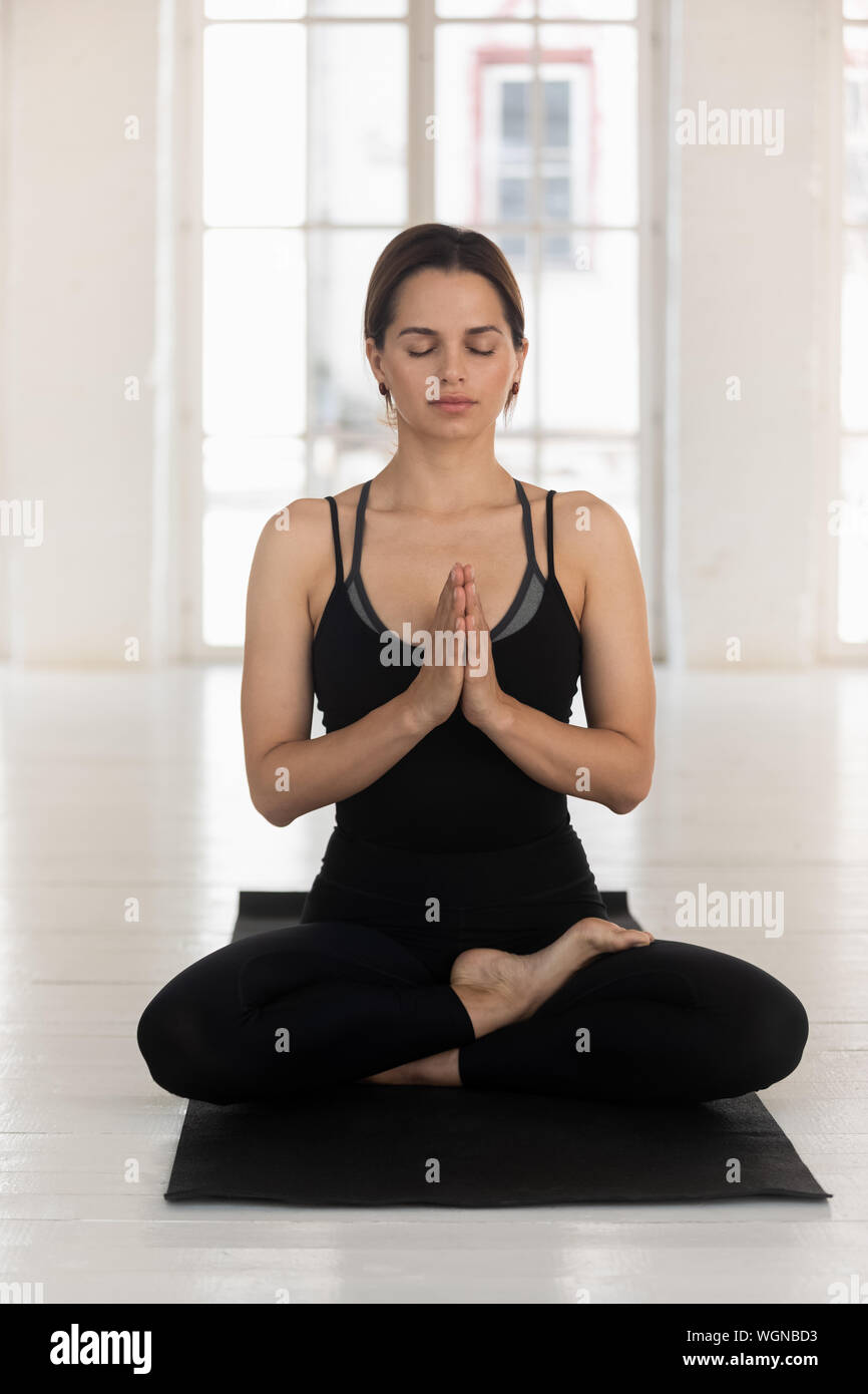 Woman with closed eyes practicing yoga, Padmasana exercise, Lotus pose ...