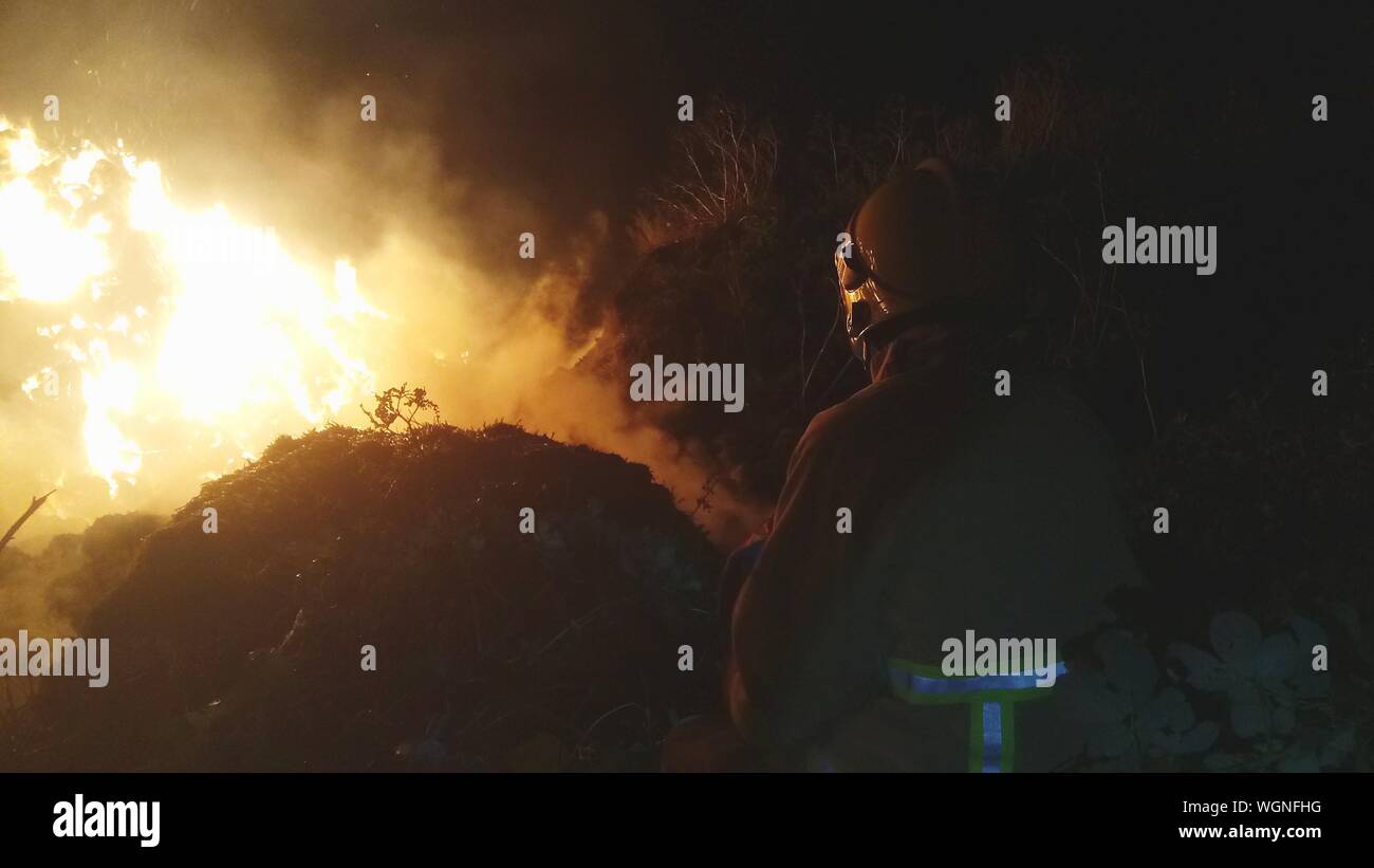 Man Standing Against Fire At Night Stock Photo - Alamy