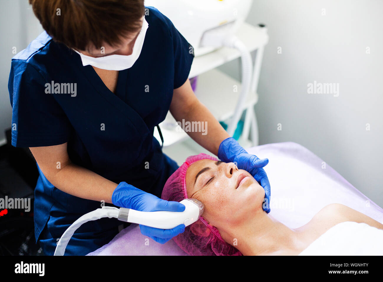 Woman getting LPG hardware massage at the beauty clinic. Professional ...
