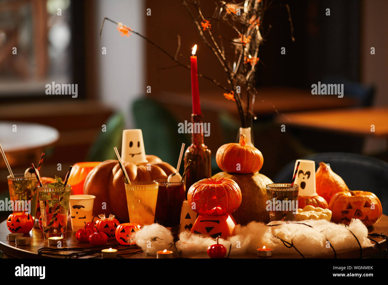 Halloween background of witches table with carved pumpkins decorations ...