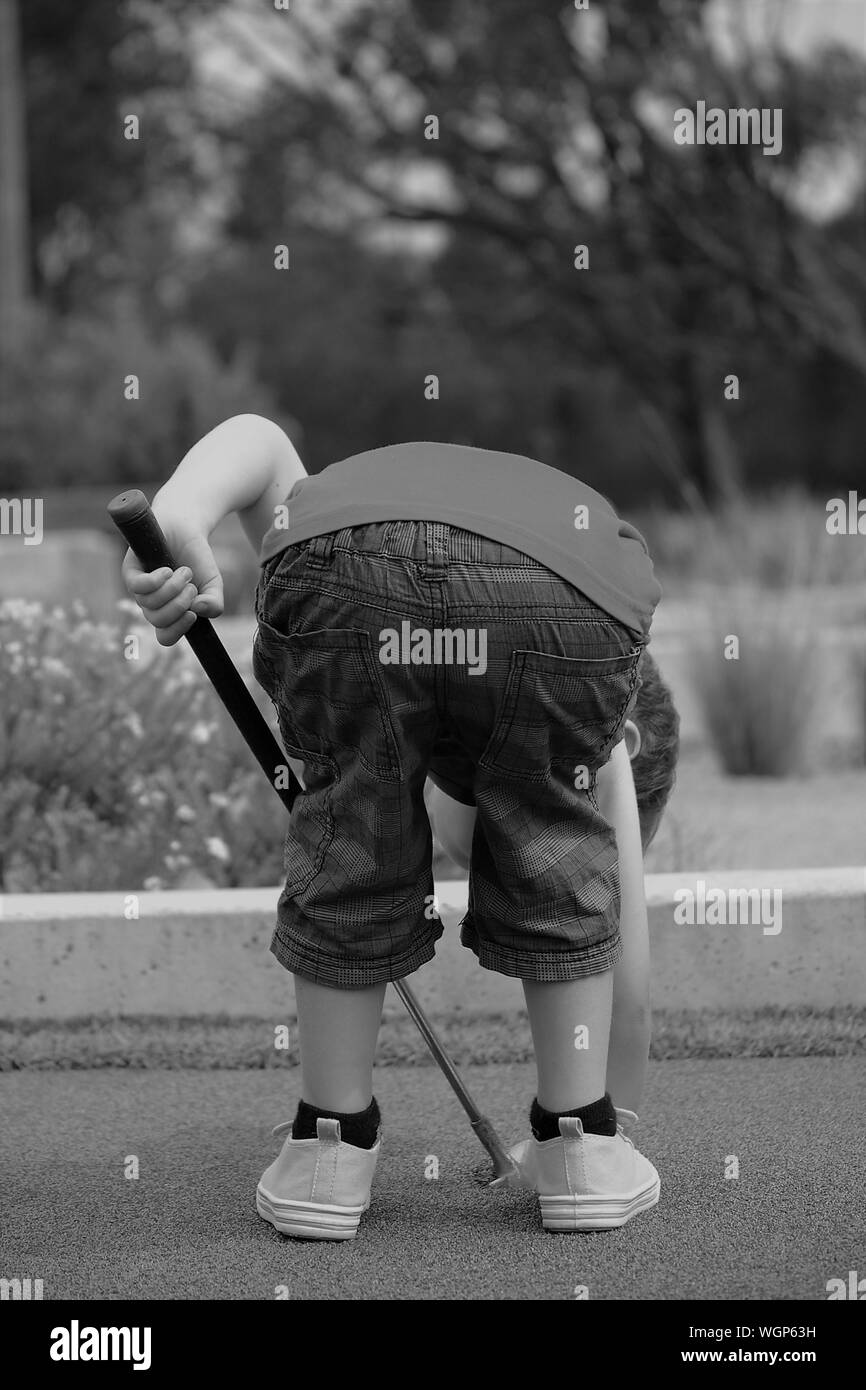 Boy playing golf Black and White Stock Photos & Images - Alamy