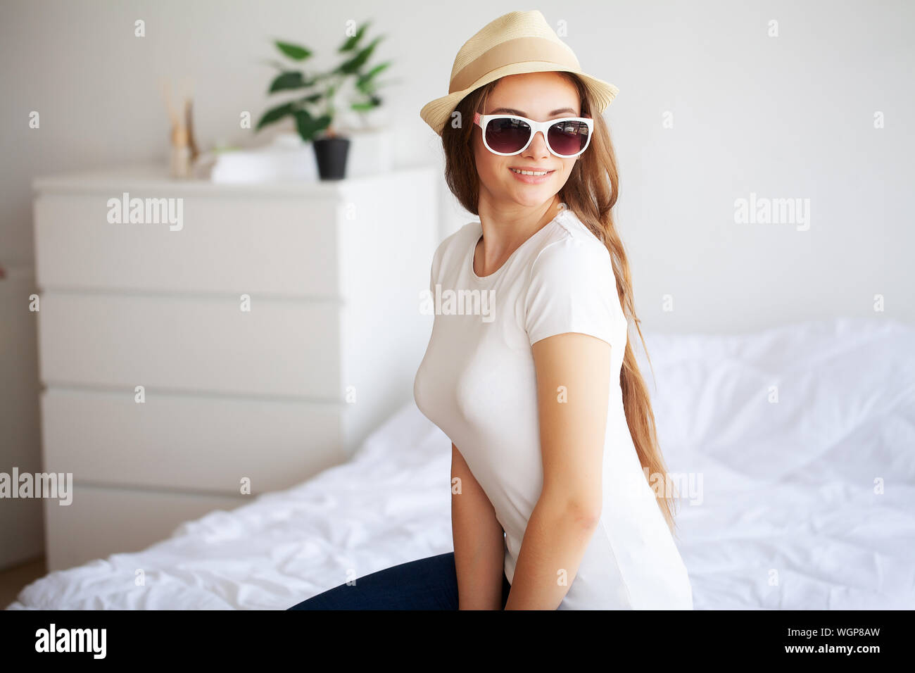 Beautiful woman is packing clothing in suitcase at home Stock Photo - Alamy